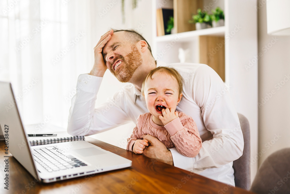 sad and frustrated father in kitchen home office with computer and her ...