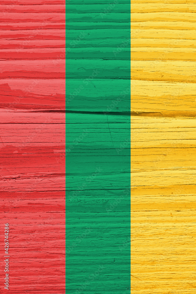 The flag of Lithuania on dry wooden surface, cracked with age. Vertical ...
