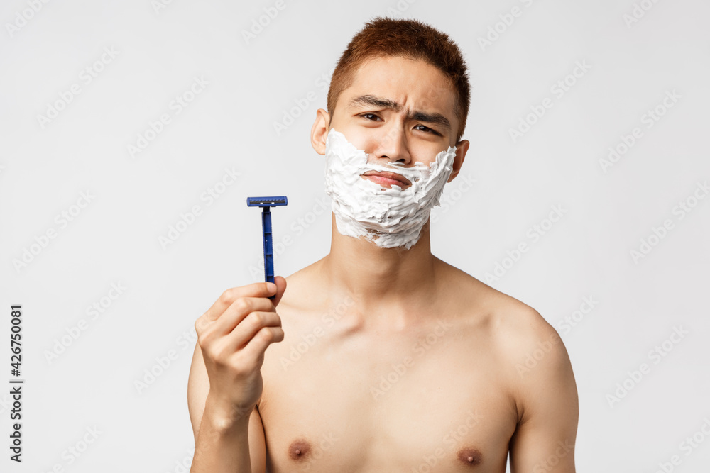 Beauty, people and hygiene concept. Reluctant and displeased asian man ...