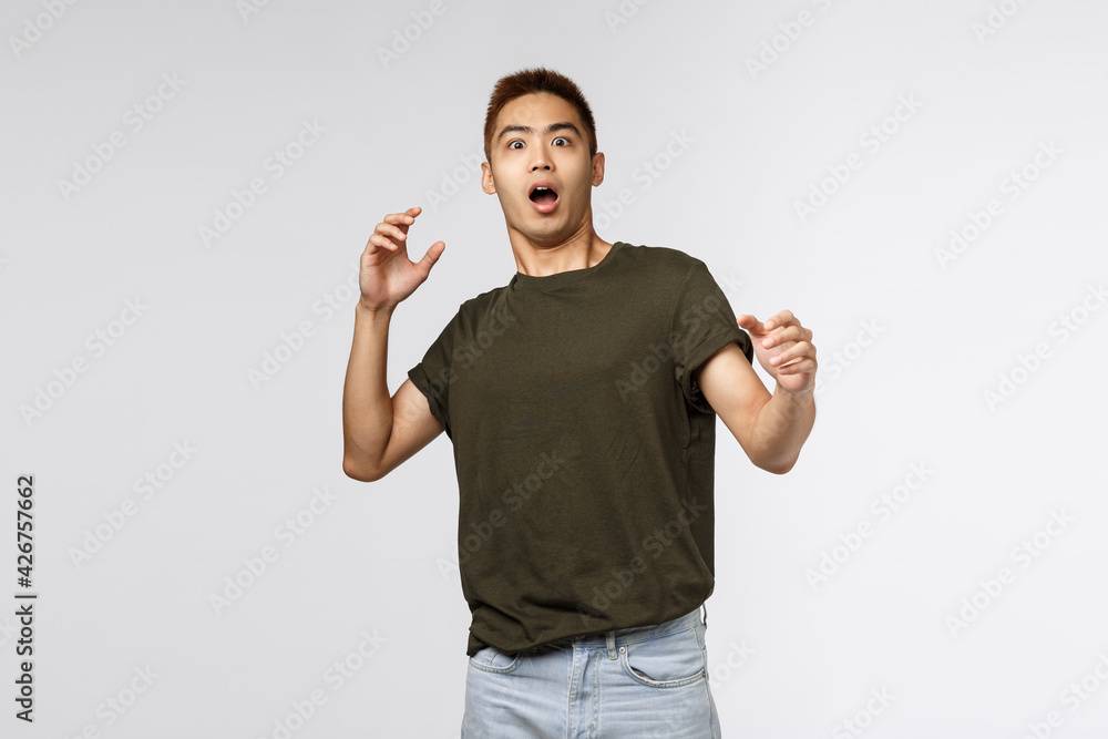 Portrait of alarmed and scared, shocked asian guy gasping, step back ...