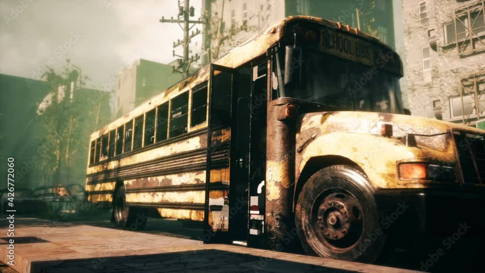 An old abandoned rusty school bus stands in the middle of the road in a ...
