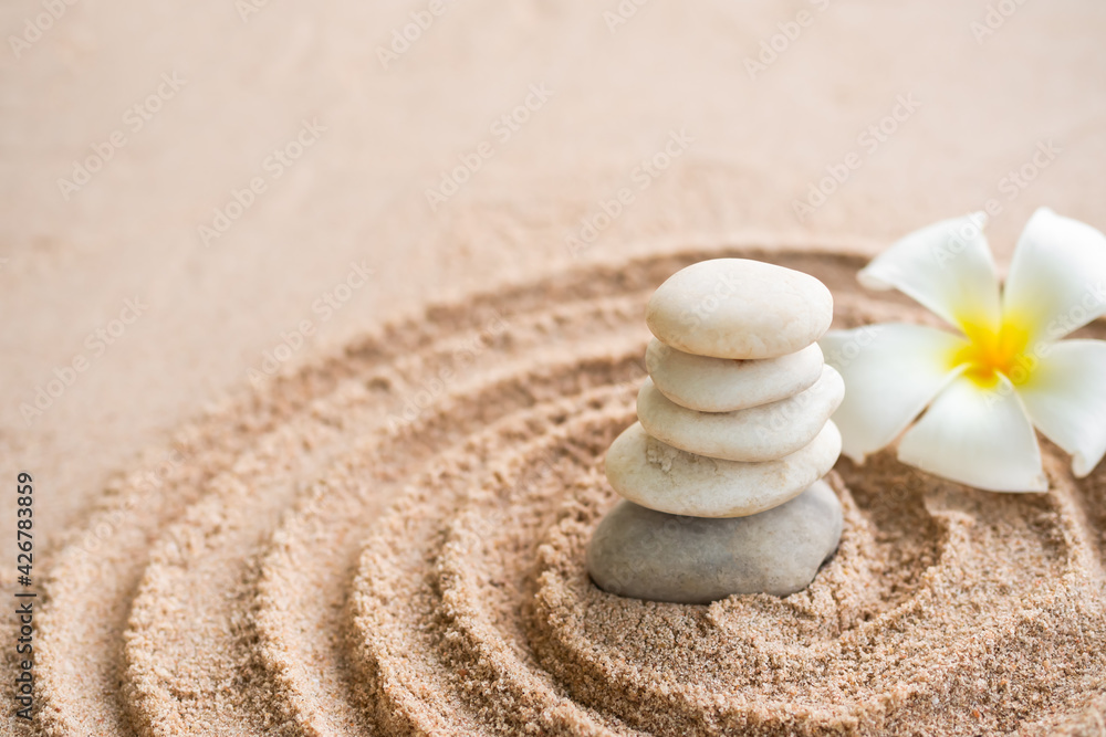 Japanese zen garden stone on sand beach. rock or pebbles with plumeria ...