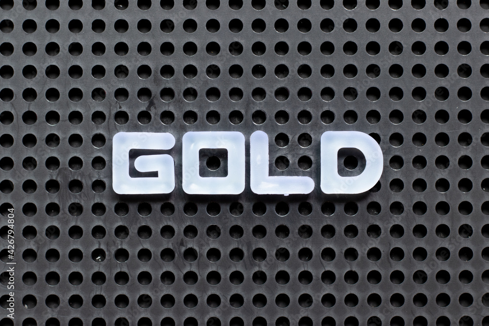 White color letter in word gold on black pegboard background Stock ...