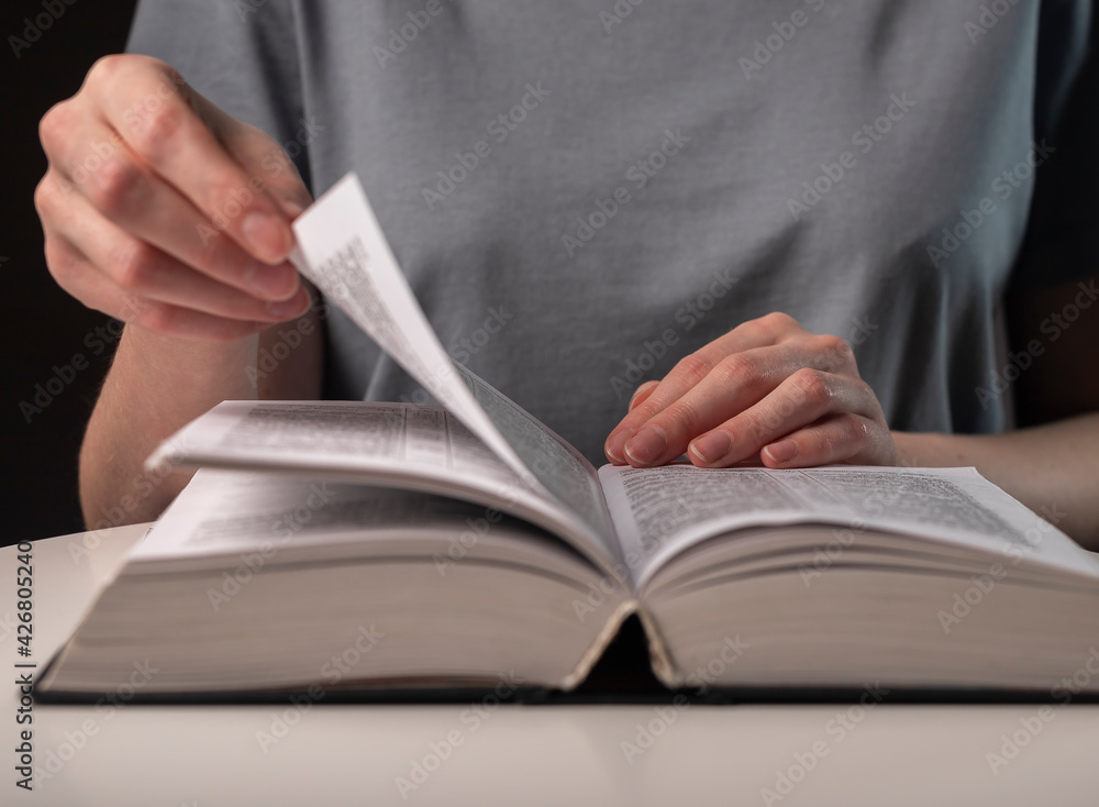 Female student hands close up, turning pages of thick book, searching ...