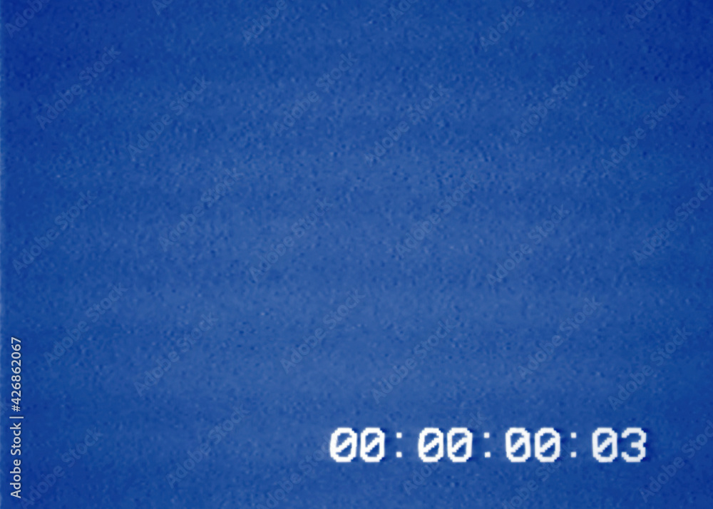 An old bad VHS tape playing, blank blue screen with timecode. A vintage ...
