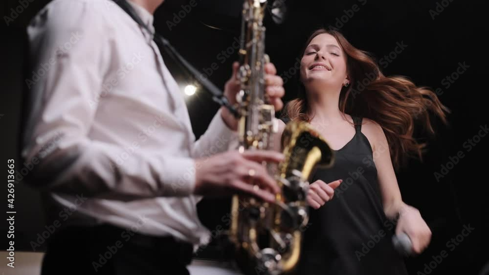 Singing girl from musical group band dancing, singing performing on ...