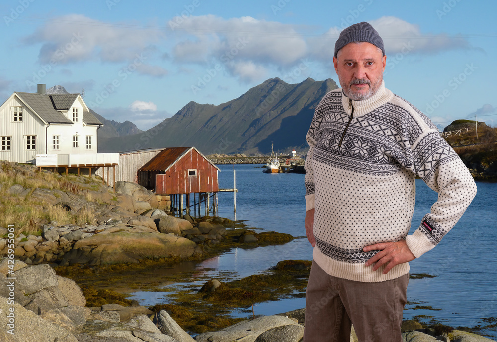 An elderly Norwegian with a beard and a typical sweater is standing on ...