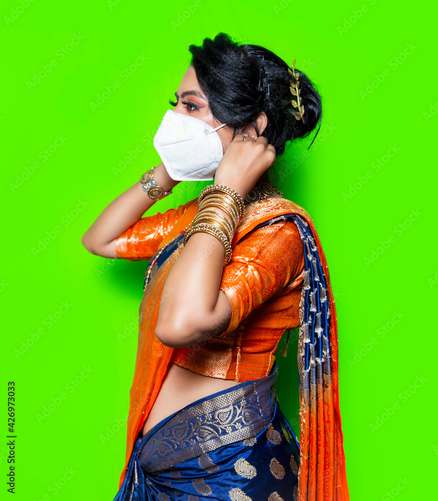 Indian traditional woman in saree wearing a white face mask, covid-19 ...