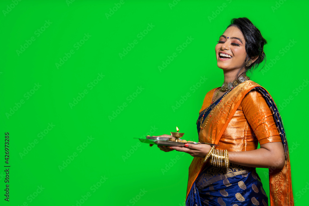 Traditional Indian woman performing worship, portrait of a beautiful ...