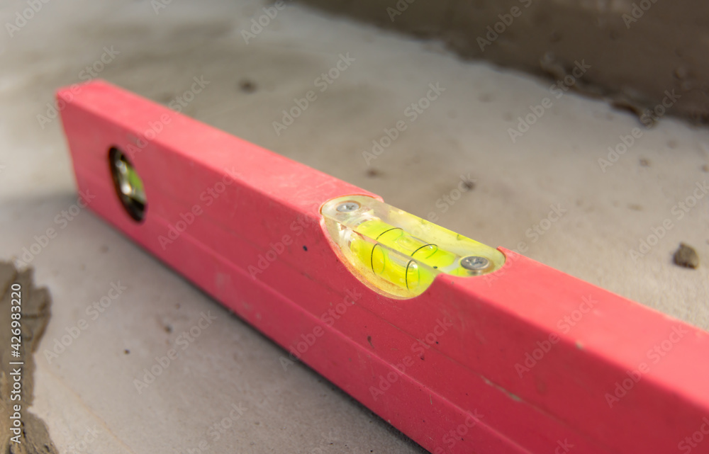 Detail of a spirit level and water bubbles for measuring the flatness ...