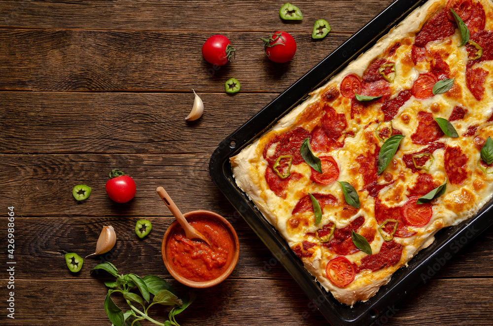 Detroit-style pizza. Square pepperoni pizza with sauce. Stock Photo ...