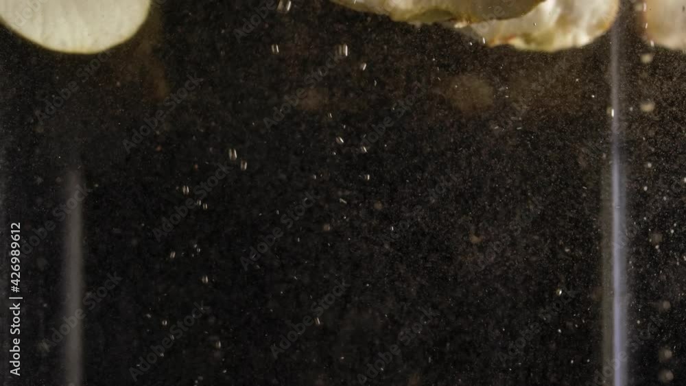 Vidéo Stock Apple slices splash falling into water isolated on black ...