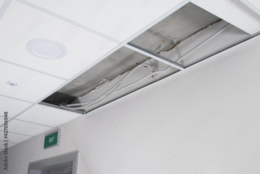 disassembled suspended ceiling and hidden wiring above it, needs repair ...