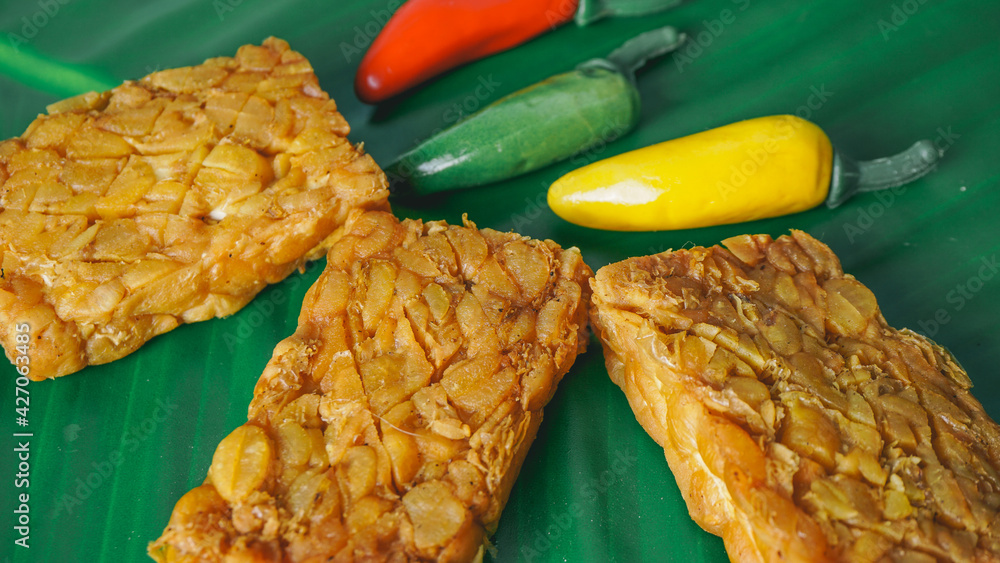 Selective Focus - Fried tempeh for snack on banana leaf. Made by a ...