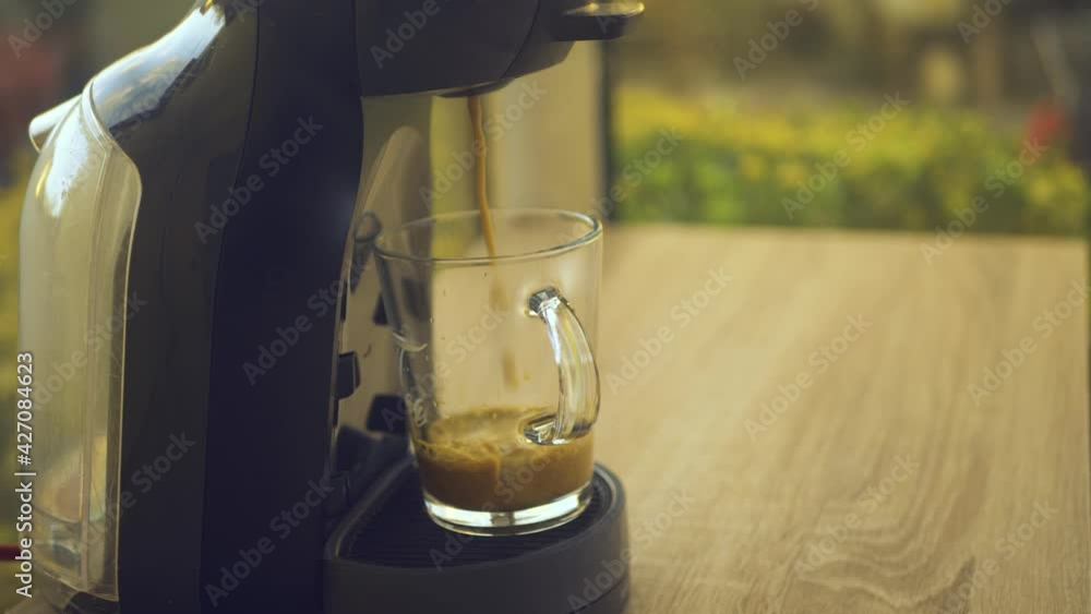 cinematic Slow motion of coffee machine making coffee in office with ...