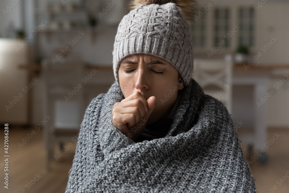 Cropped shot of ill millennial latina woman sit at home under warm ...