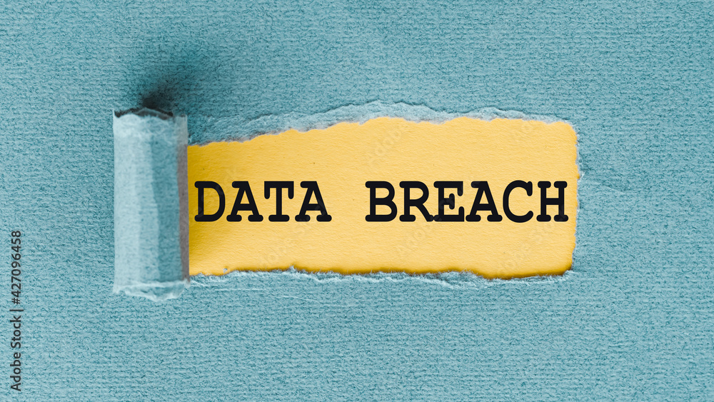 DATA BREACH words written under ripped and torn paper. Stock Photo ...