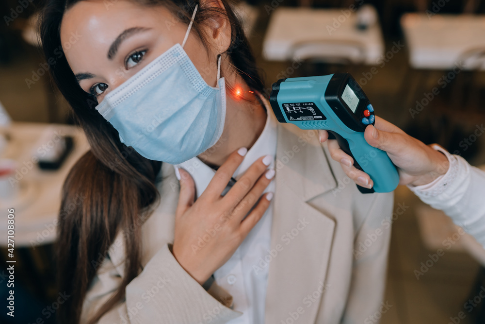 Measuring body temperature with contactless body thermometer Stock ...