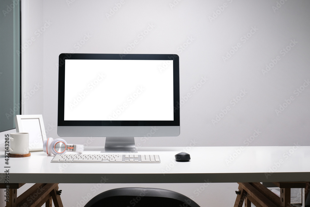 Modern workspace with computer with blank screen and equipment on white ...