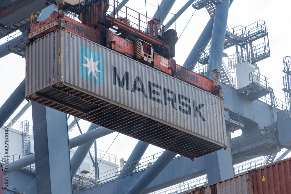 Gantry crane loading Maersk owned container on board of cargo ship ...