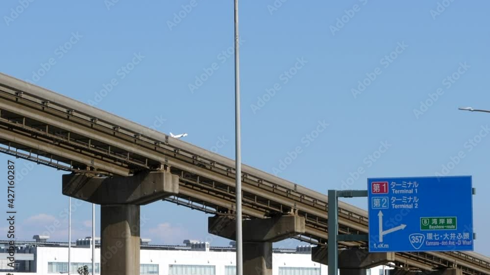 Monorail and plane taking off in background, outskirts of Haneda ...