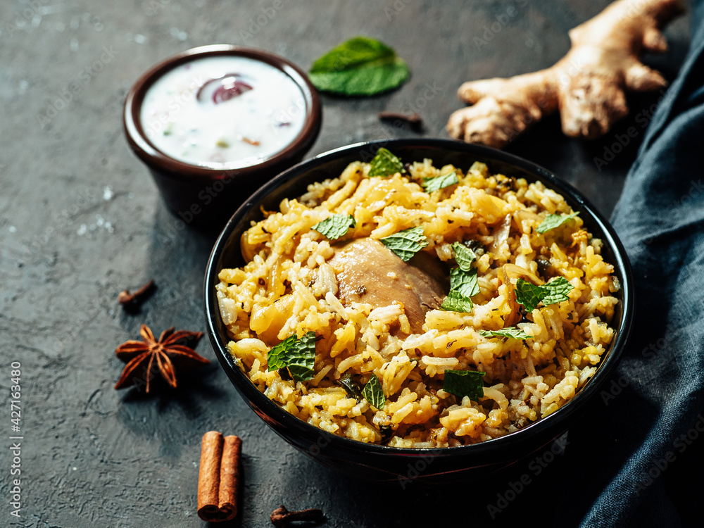 Pakistani food - biryani rice with chicken and raita yoghurt dip ...