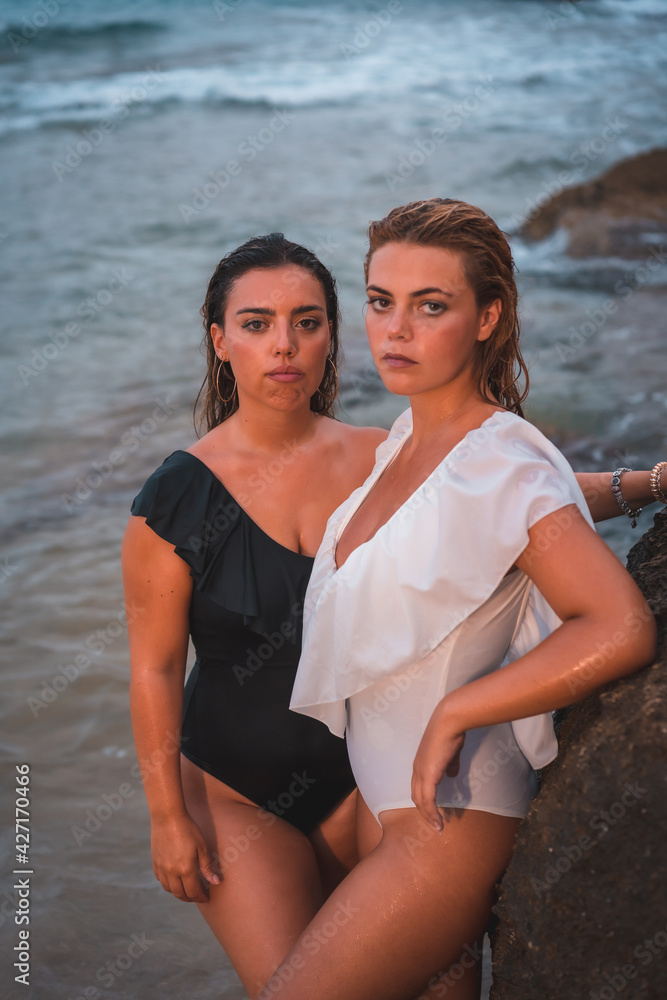 Lifestyle of a couple of lesbian Caucasian girls on the beach in summer ...