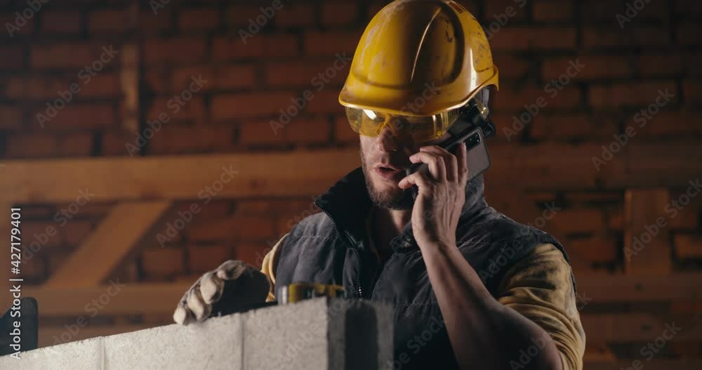 Man answering phone call on construction site Stock Video | Adobe Stock