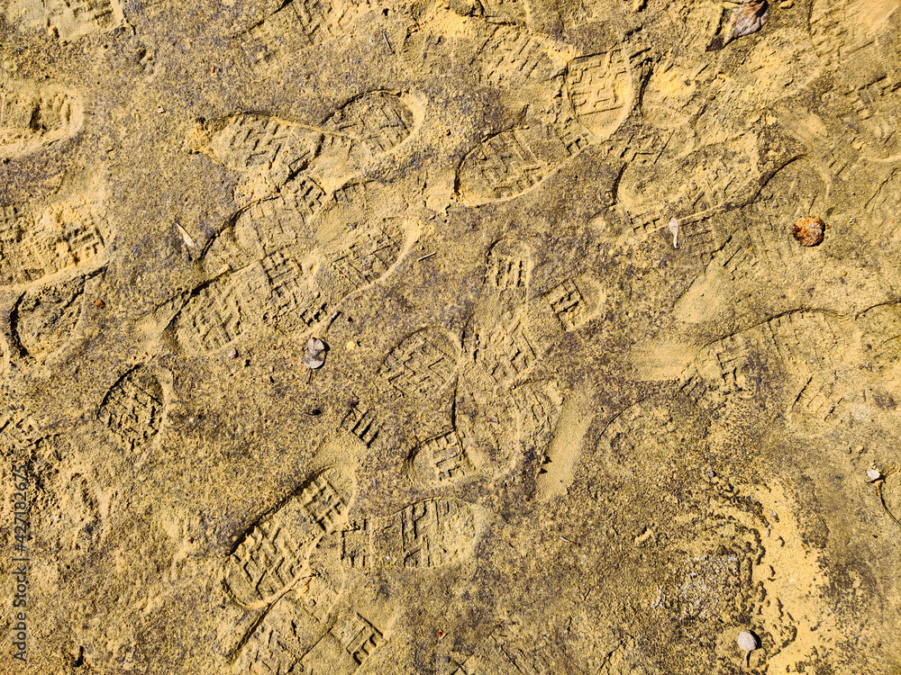 Footprints of boots on the wet sand. Texture of prints, background ...