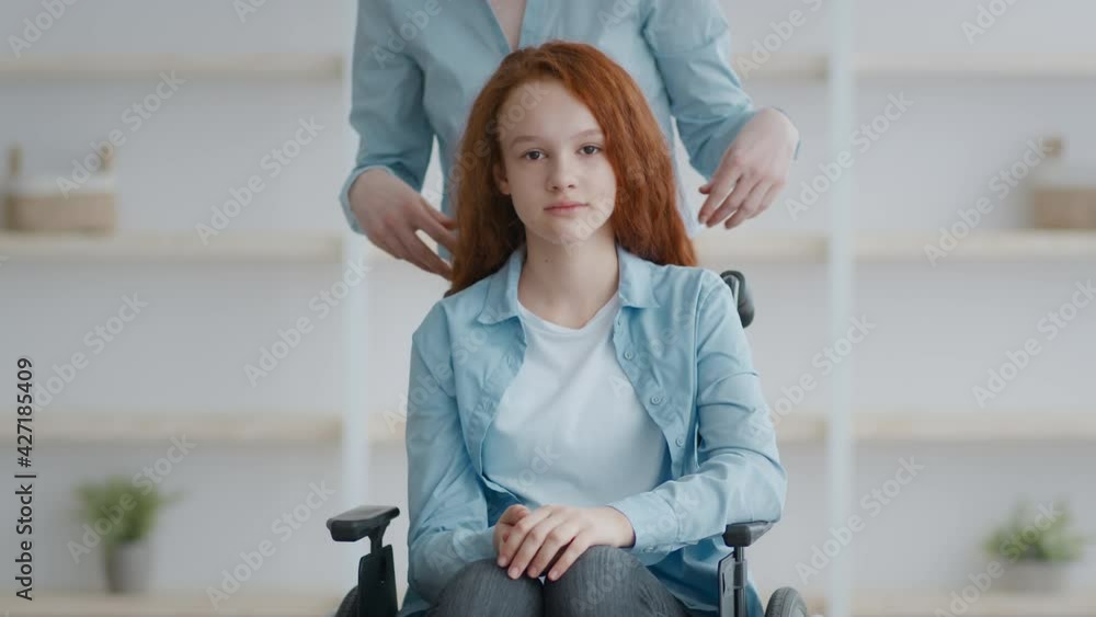 Kid disability and parent love. Little redhead paralyzed girl sitting ...