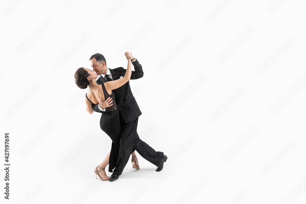 Couple of professional tango dancers in elegant suit and dress pose in ...