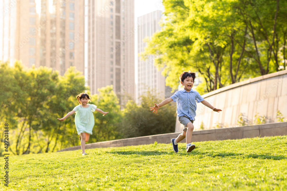 Happy children playing in park Stock Photo | Adobe Stock