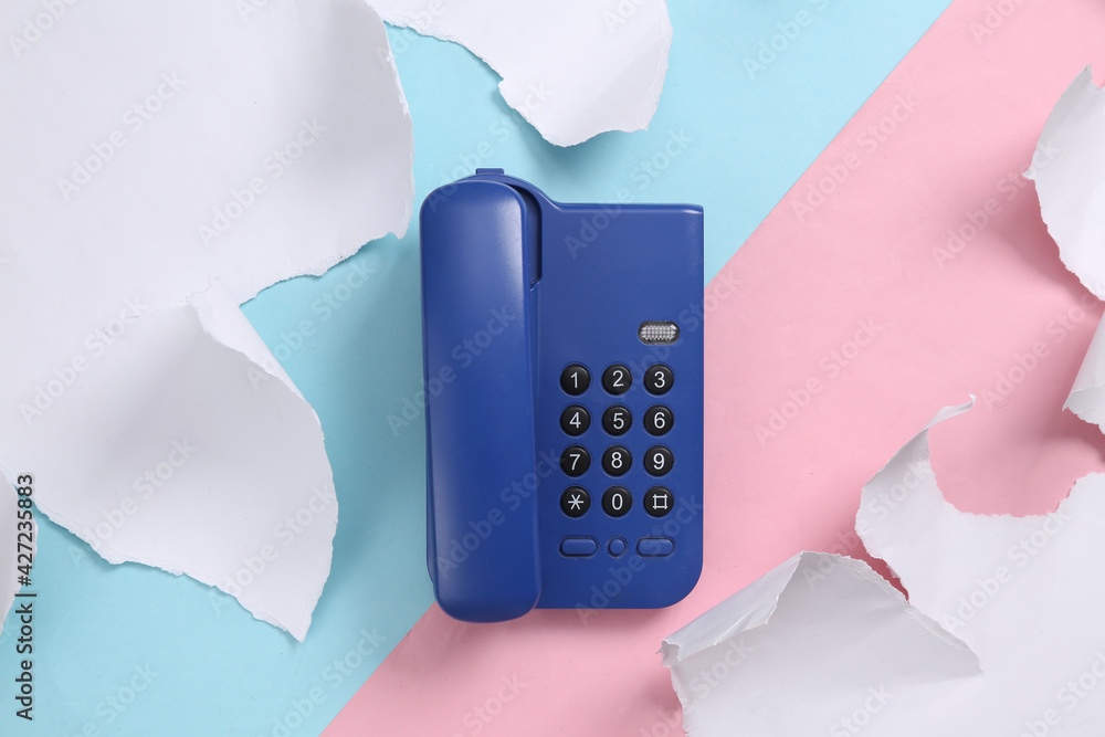 Office phone on blue-pink background with torn paper. Concept art ...