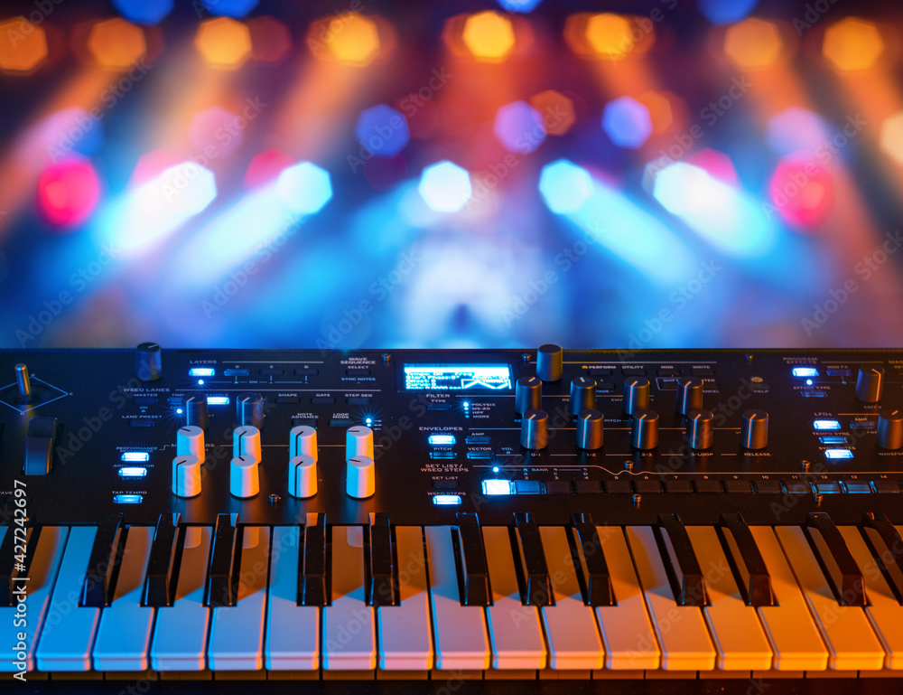 Musical instrument electronic synthesizer on a background of colored ...