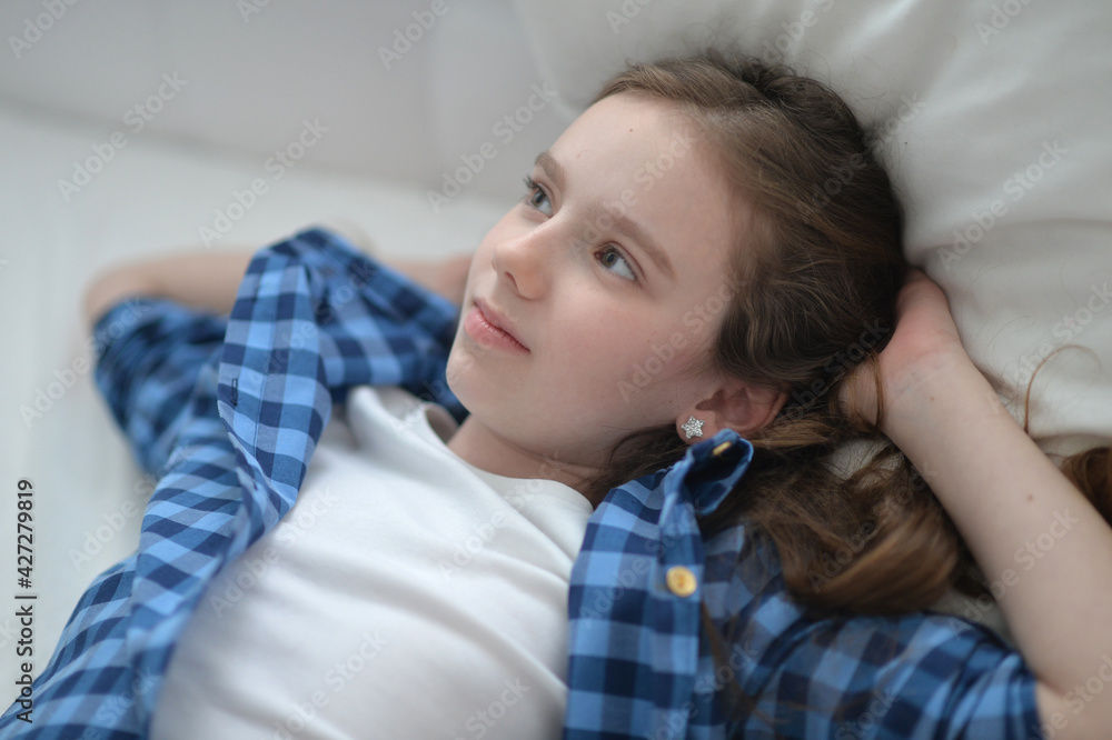 Cute little girl lying in bed at home Stock Photo | Adobe Stock