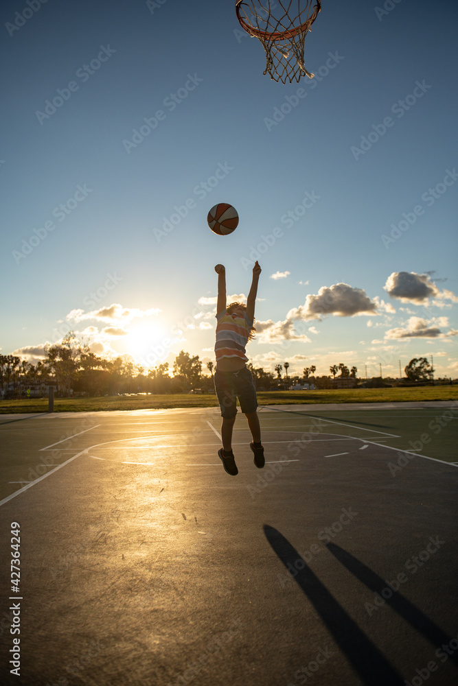 Cute child playing basketball. Cute little boy child jumping with ...