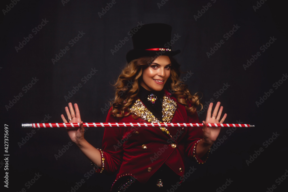 Female magician illusionist circus with wand in theatrical clothes ...