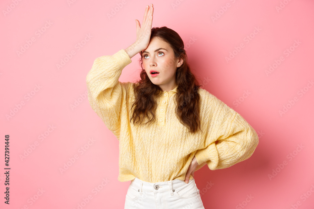 Oh me god. Annoyed and tired young woman slap her forehead with palm ...