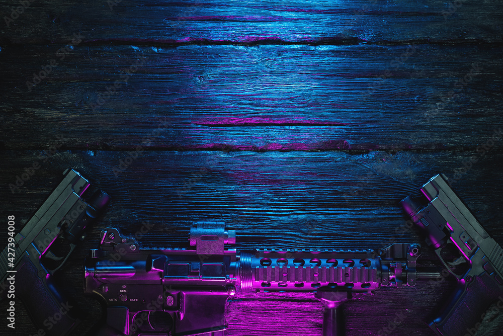 Airsoft rifle and guns on the flat lay table background with copy space ...