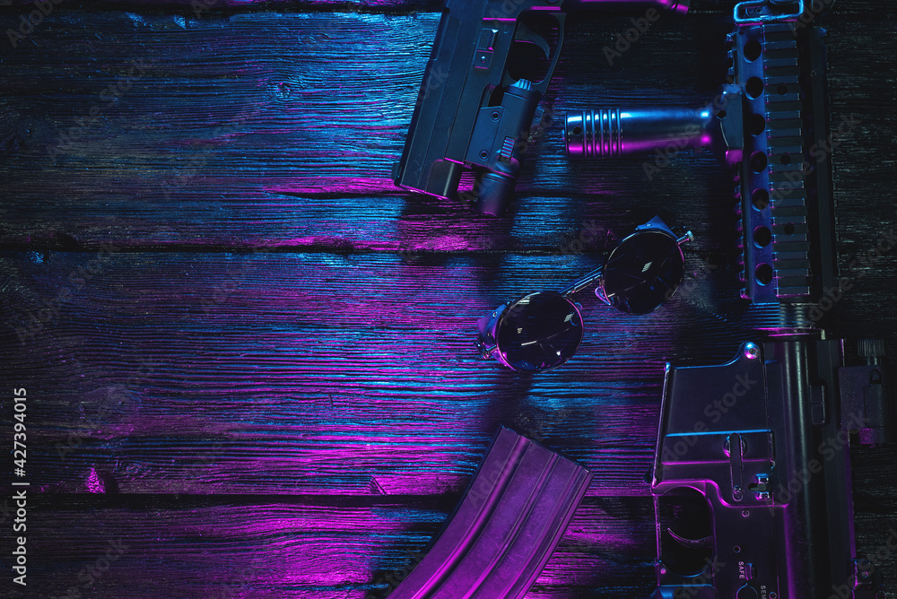 Airsoft rifle and guns on the flat lay table background with copy space ...