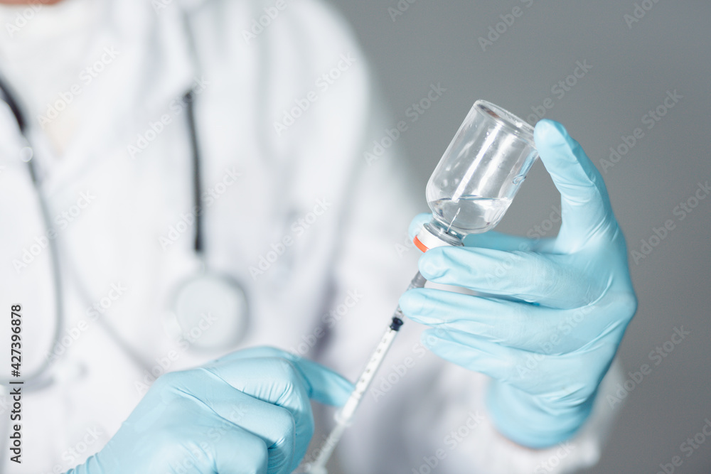 A doctor or scientist in a laboratory develops a medical vaccine. Holds ...