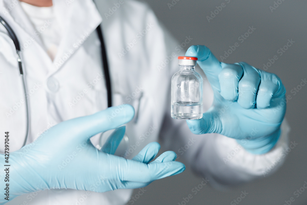 A doctor or scientist in a laboratory develops a medical vaccine. Holds ...