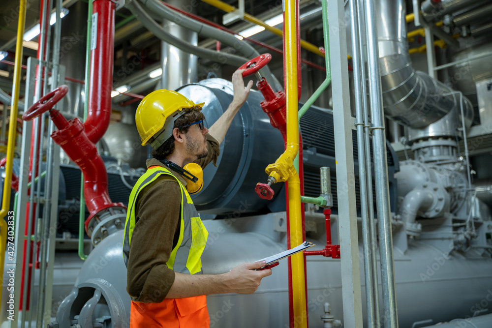 Electrical engineer working in control room of a modern thermal power ...