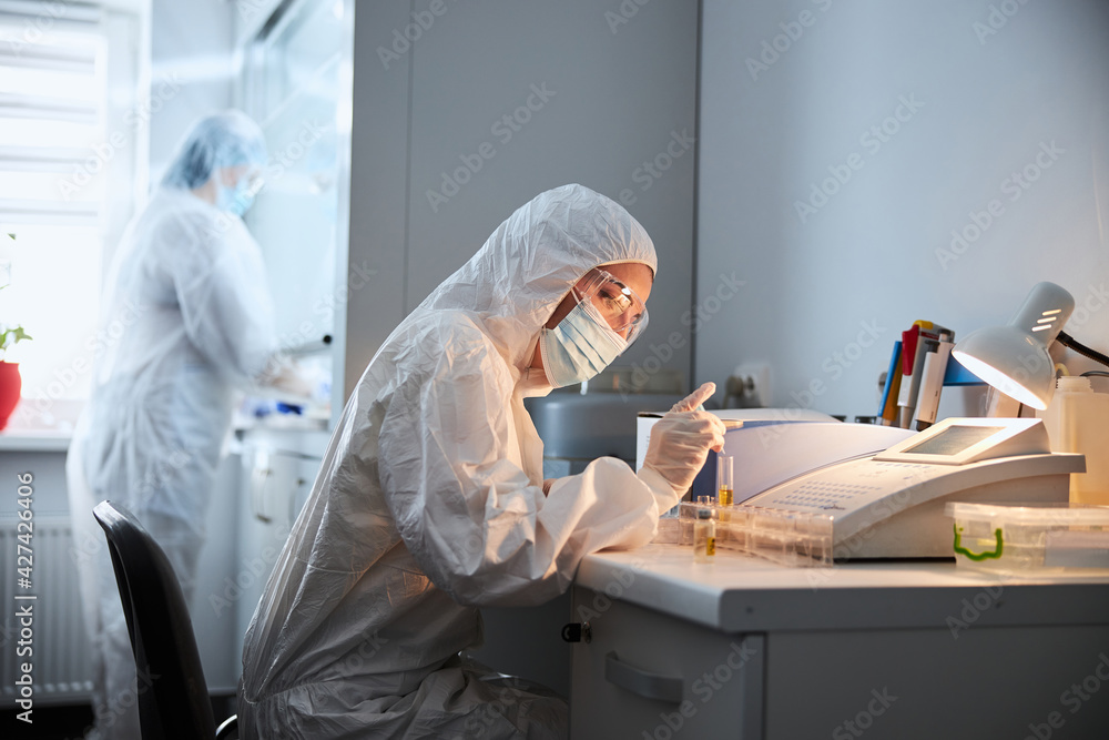 Two virologists performing chemical tests in a research lab Stock Photo ...