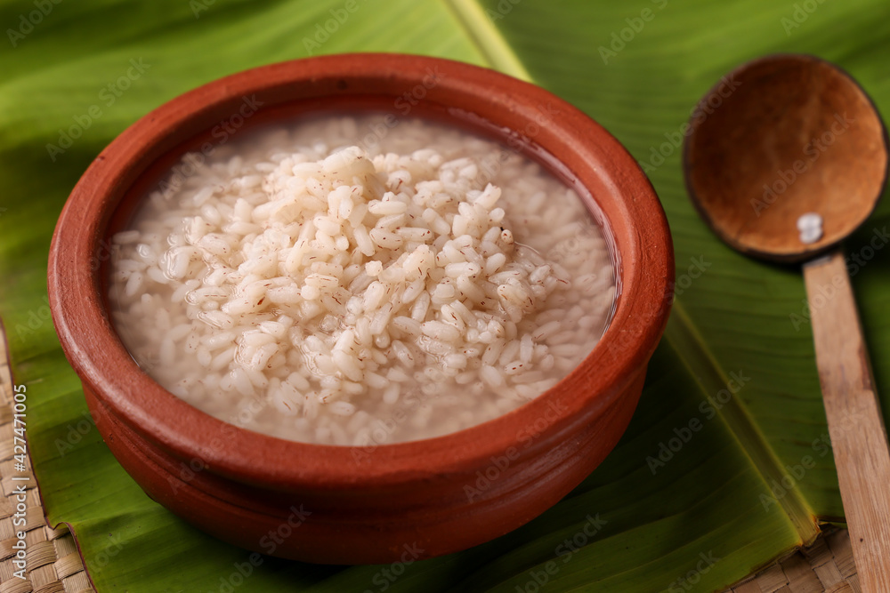 Rice porridge, Kanji, gruel in clay pot palm mat background Kerala ...