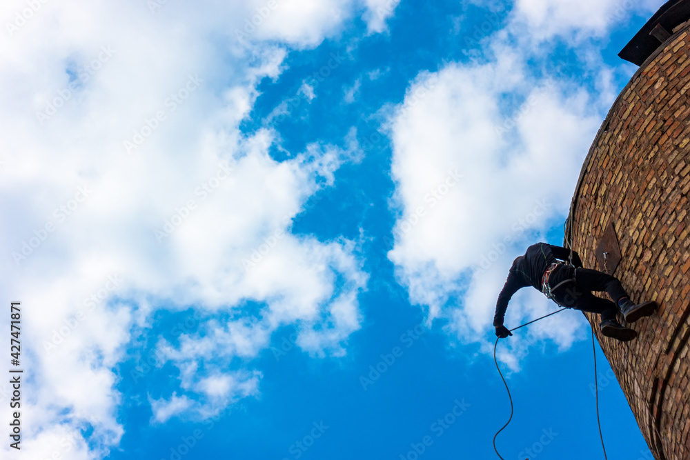 Man on top of a water tower Stock Photo | Adobe Stock