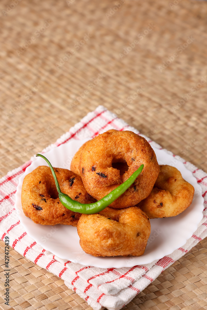 Medu Vada with tiffin sambar coconut chutney in traditional background ...