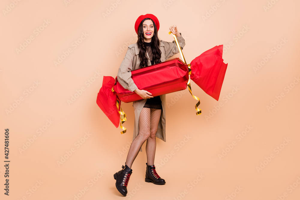 Full length photo portrait of woman unwrapping big red candy isolated ...