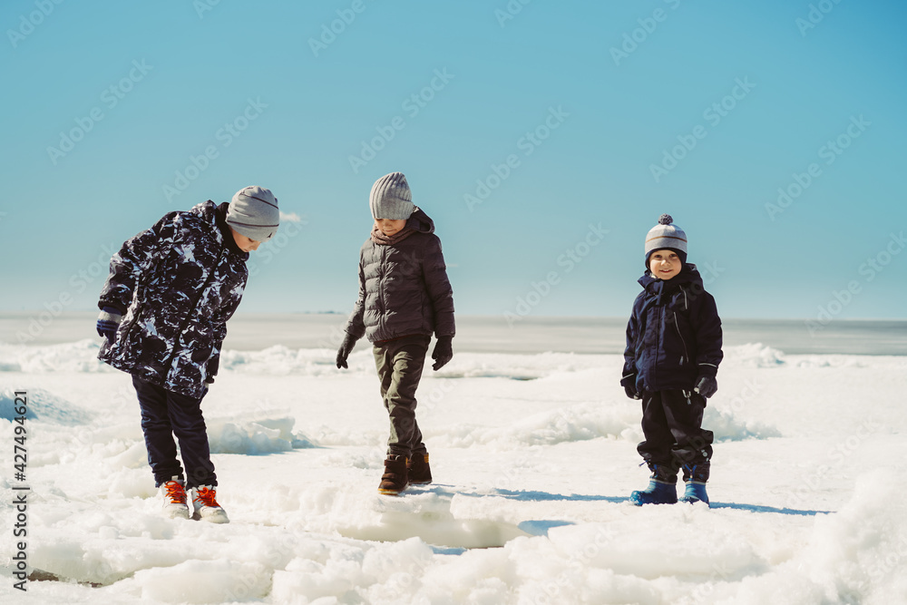 Foto de children walking on ice piling of finland gulf. image with ...