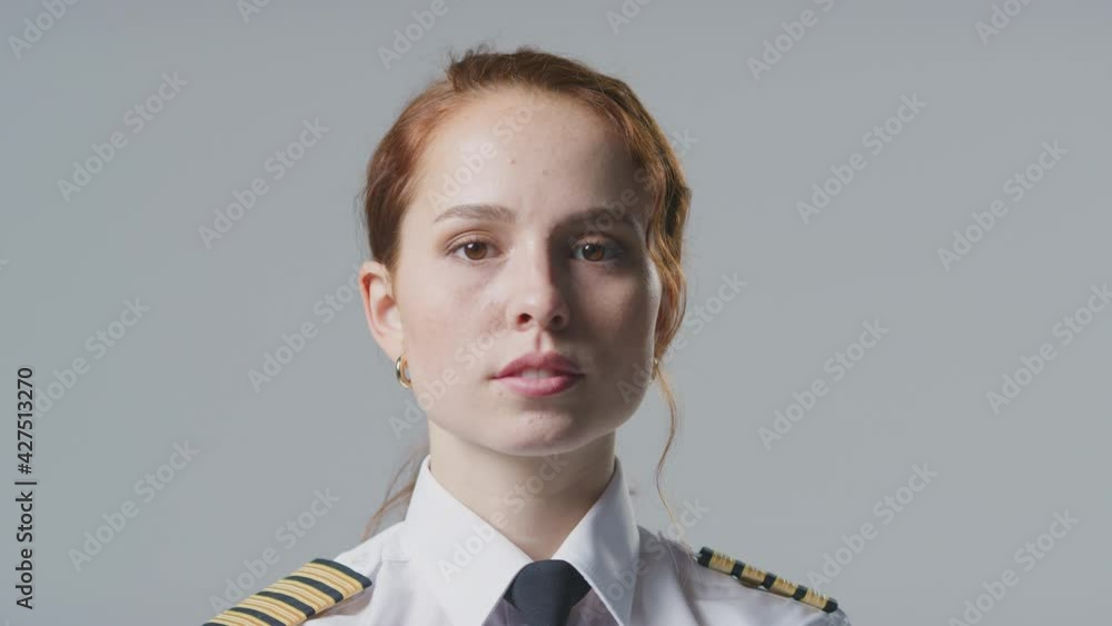 Vídeo do Stock: Serious young female airline pilot or ship captain ...